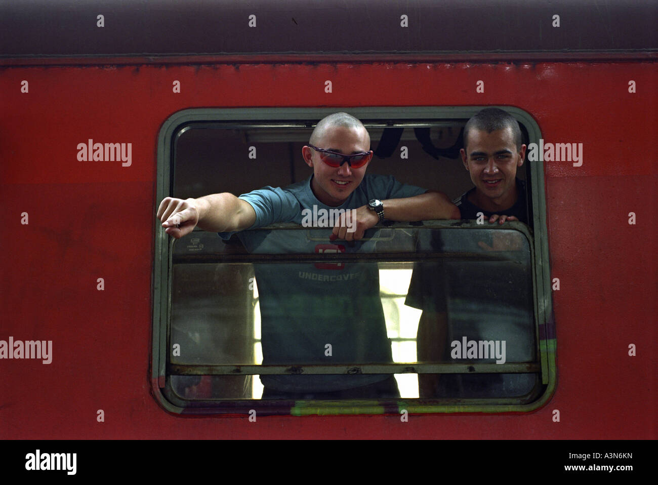 Two teenagers looking out of the train window, Poland Stock Photo - Alamy