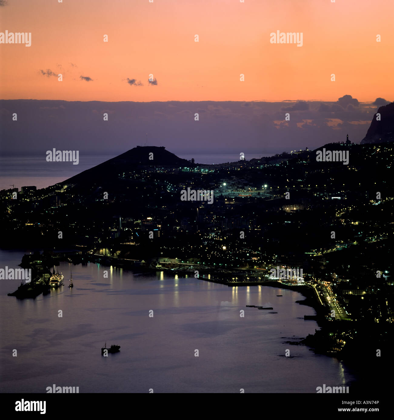 FUNCHAL TOWN SKYLINE WITH HARBOUR AND SEA COASTLINE AERIAL AT DUSK ...