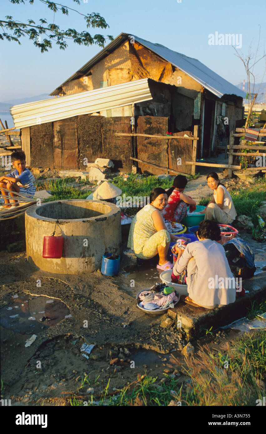 Poor family collecting water from communal well in city of Nha Trang ...