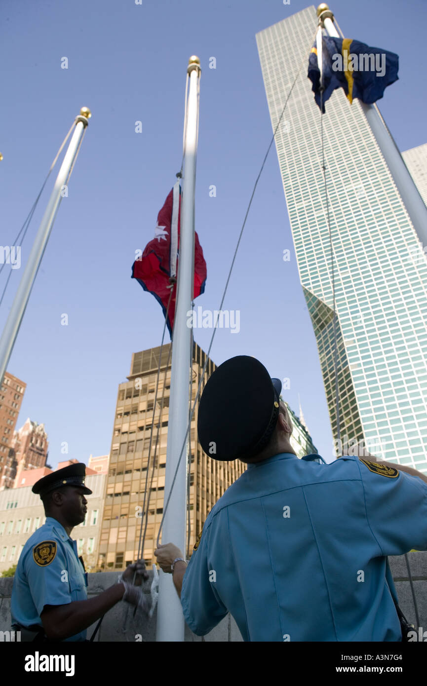 Security guards raise member states flags in front of the UN general ...