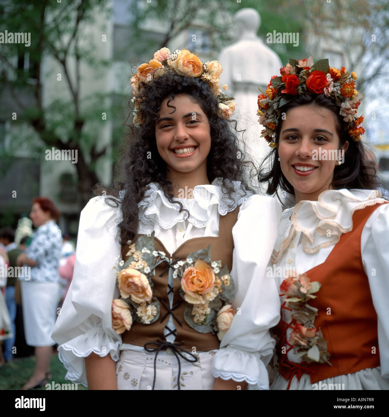 TWO YOUNG WOMEN WITH TRADITIONAL COSTUME AND FLOWER HEADDRESS AT SPRING ...