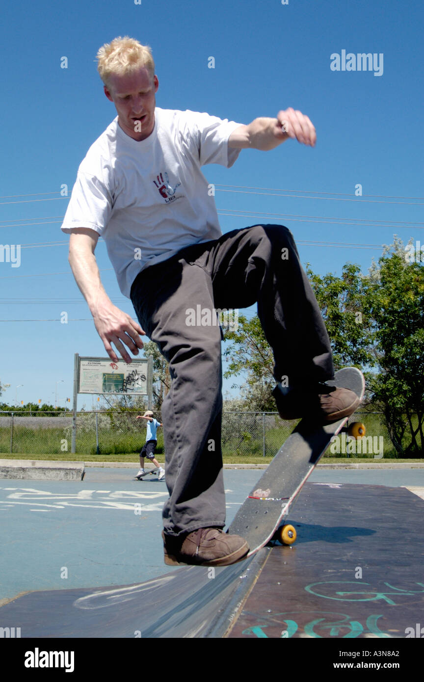 Skateboarder on top of ramp Stock Photo - Alamy