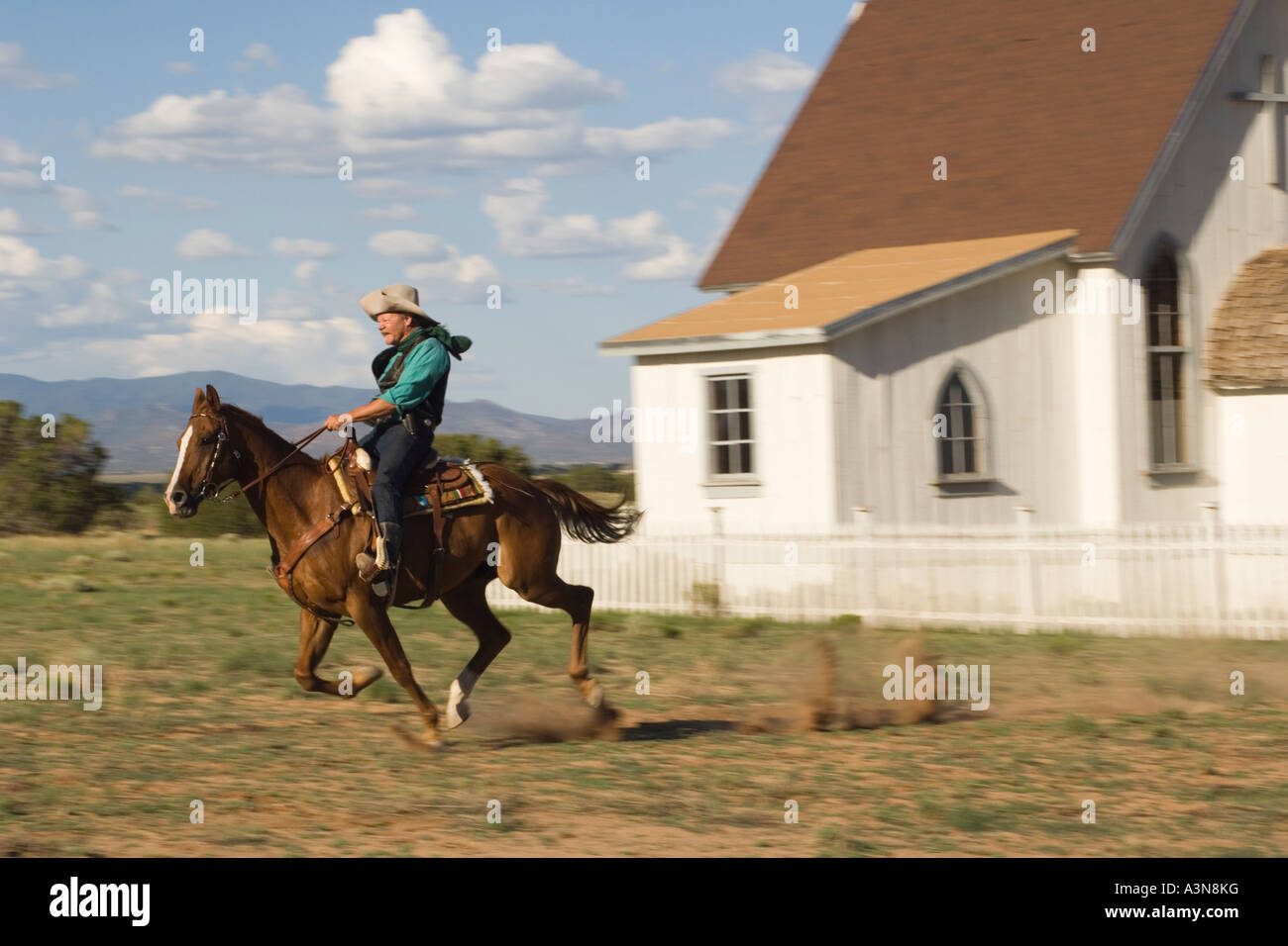 Cowboy and running horse Stock Photo - Alamy