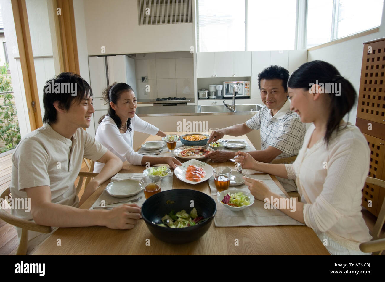 Family eating lunch at home Stock Photo - Alamy