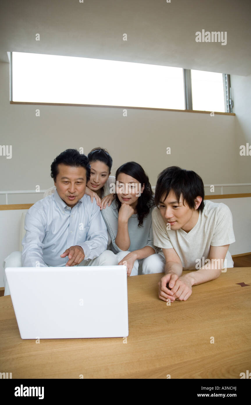 Family looking at computer Stock Photo - Alamy