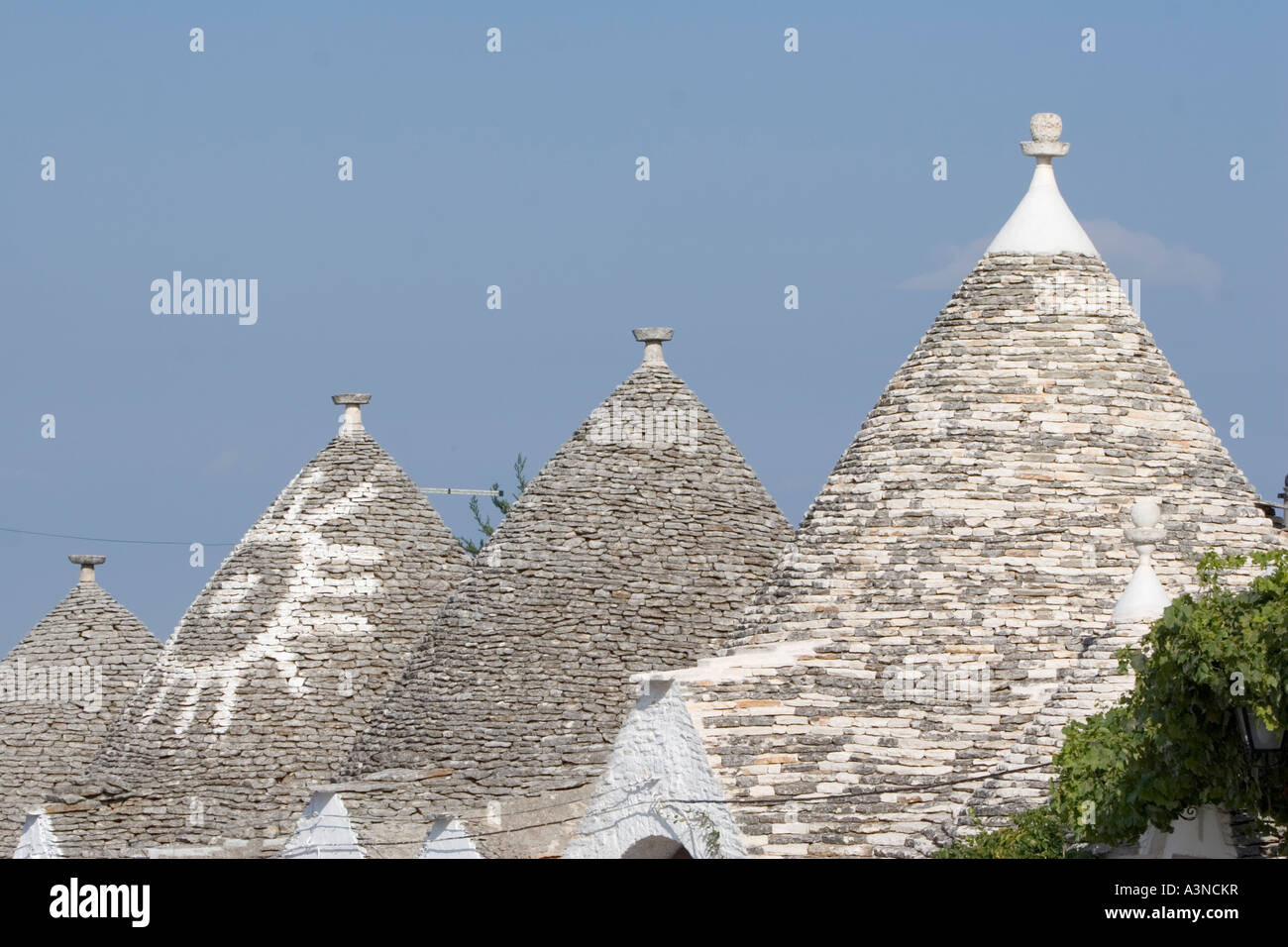 Conical rooves of trulli houses, painted with a traditional symbol ...
