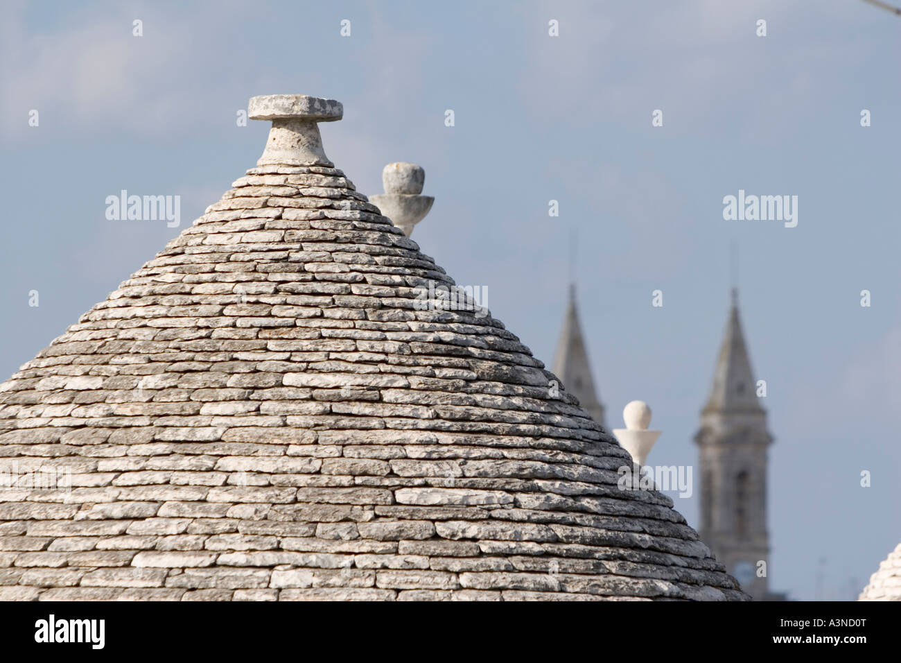 Conical roof of trullo house with cathedral Basilica S. Medici ...