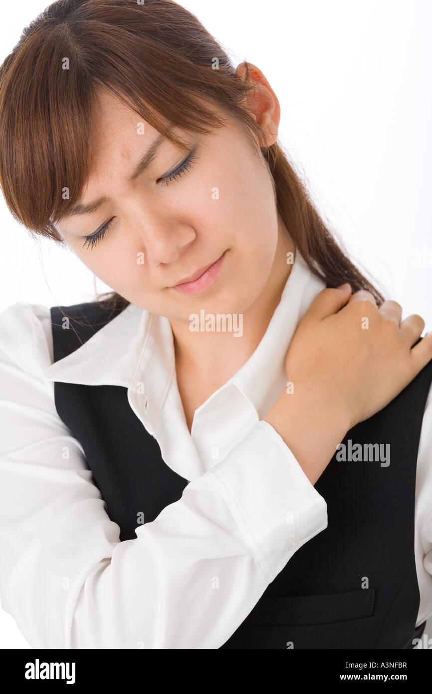 A young woman massaging shoulder Stock Photo - Alamy