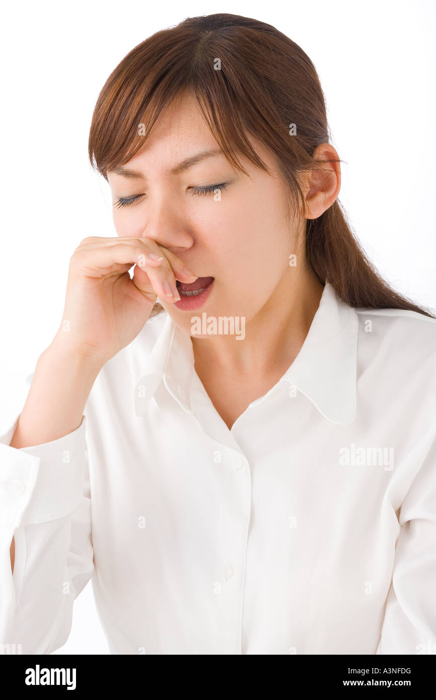 A young woman sneezing Stock Photo - Alamy