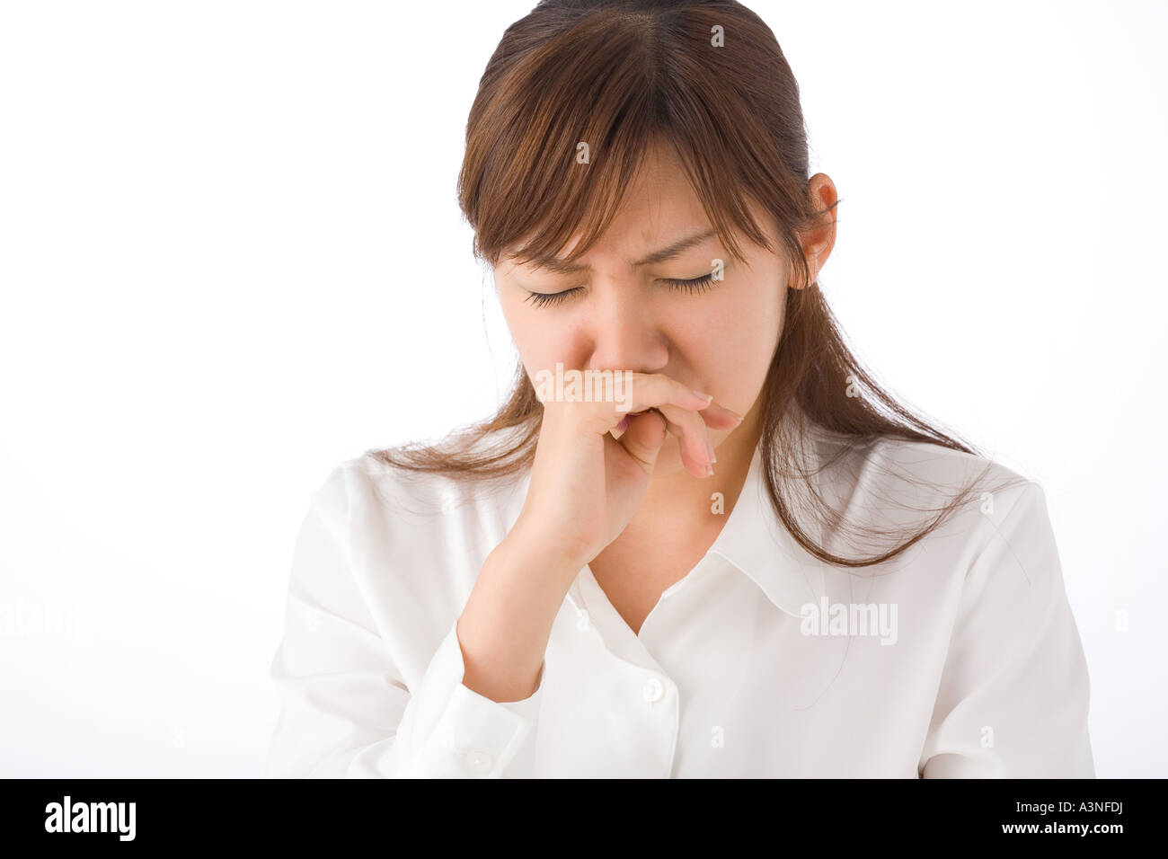 A young woman sneezing Stock Photo - Alamy