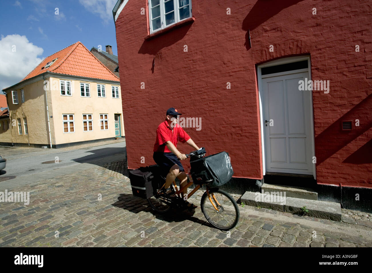 Postman delivering mail by bike Ribe Jutland Denmark Stock Photo - Alamy
