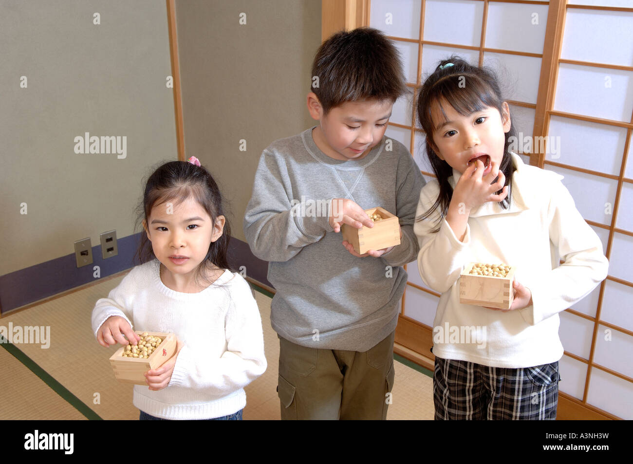Children eating roasted beans Stock Photo - Alamy