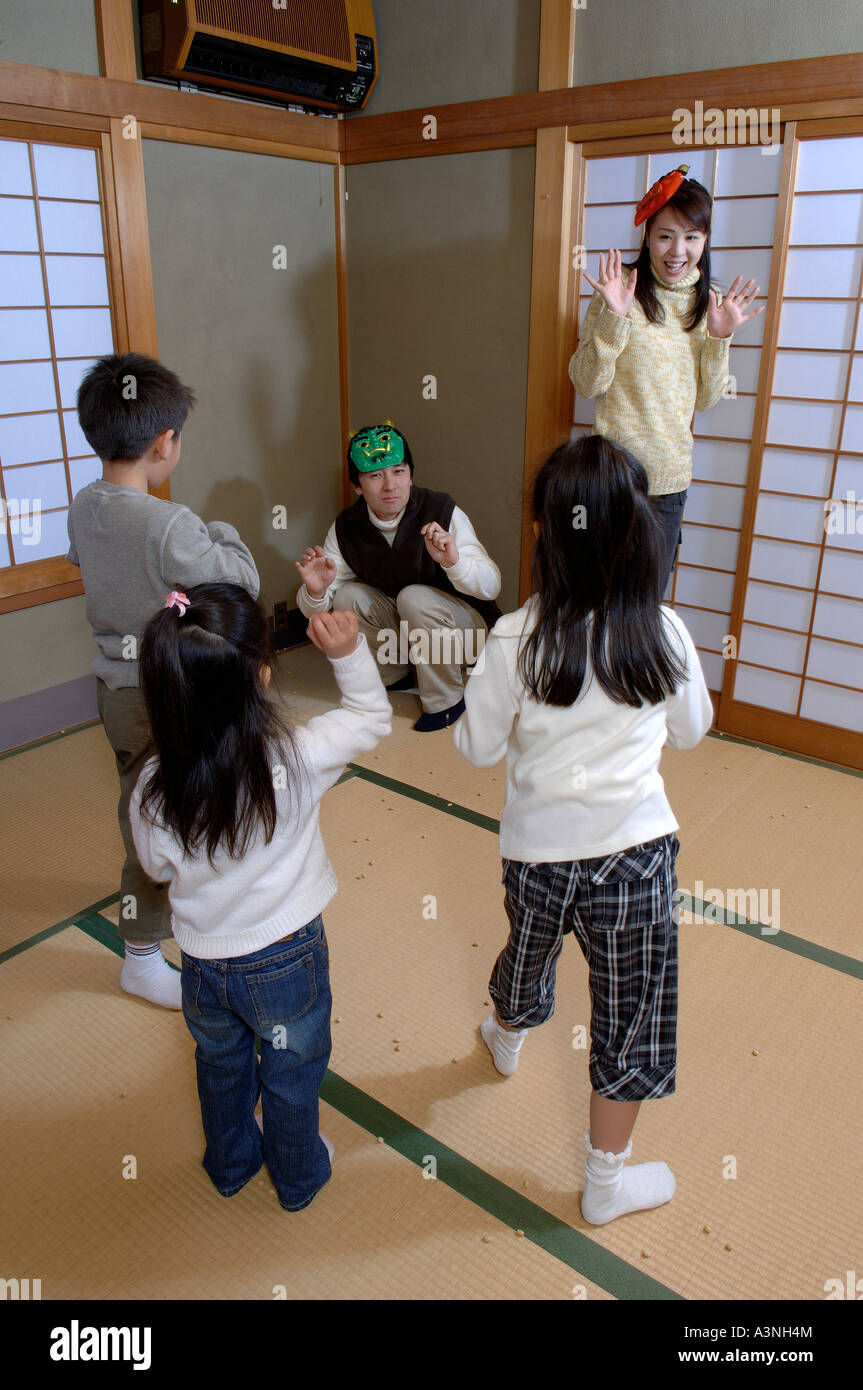 Children throwing roasted beans for setsubun festival Stock Photo - Alamy