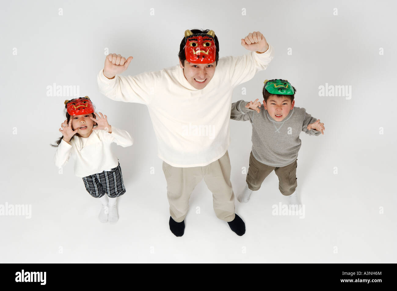 Father and children wearing mask of evil Stock Photo - Alamy