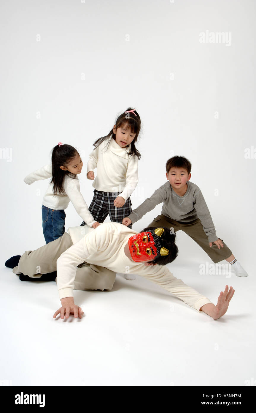 Father wearing mask of evil and children Stock Photo - Alamy