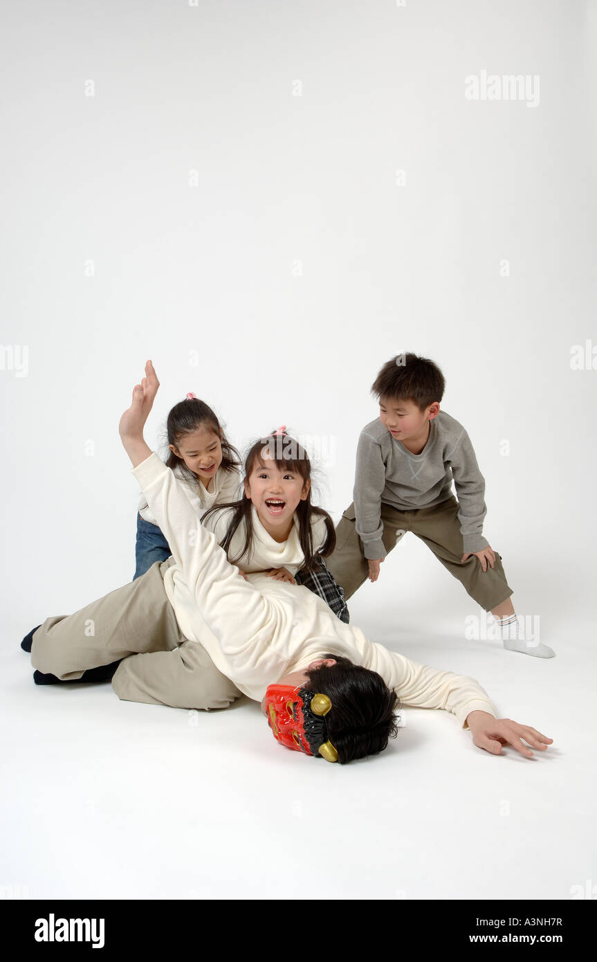 Father wearing mask of evil and children Stock Photo - Alamy