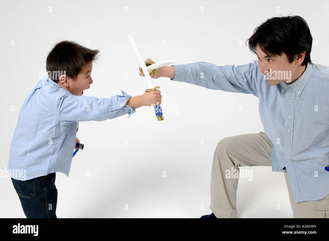 Father son playing sword hi-res stock photography and images - Alamy