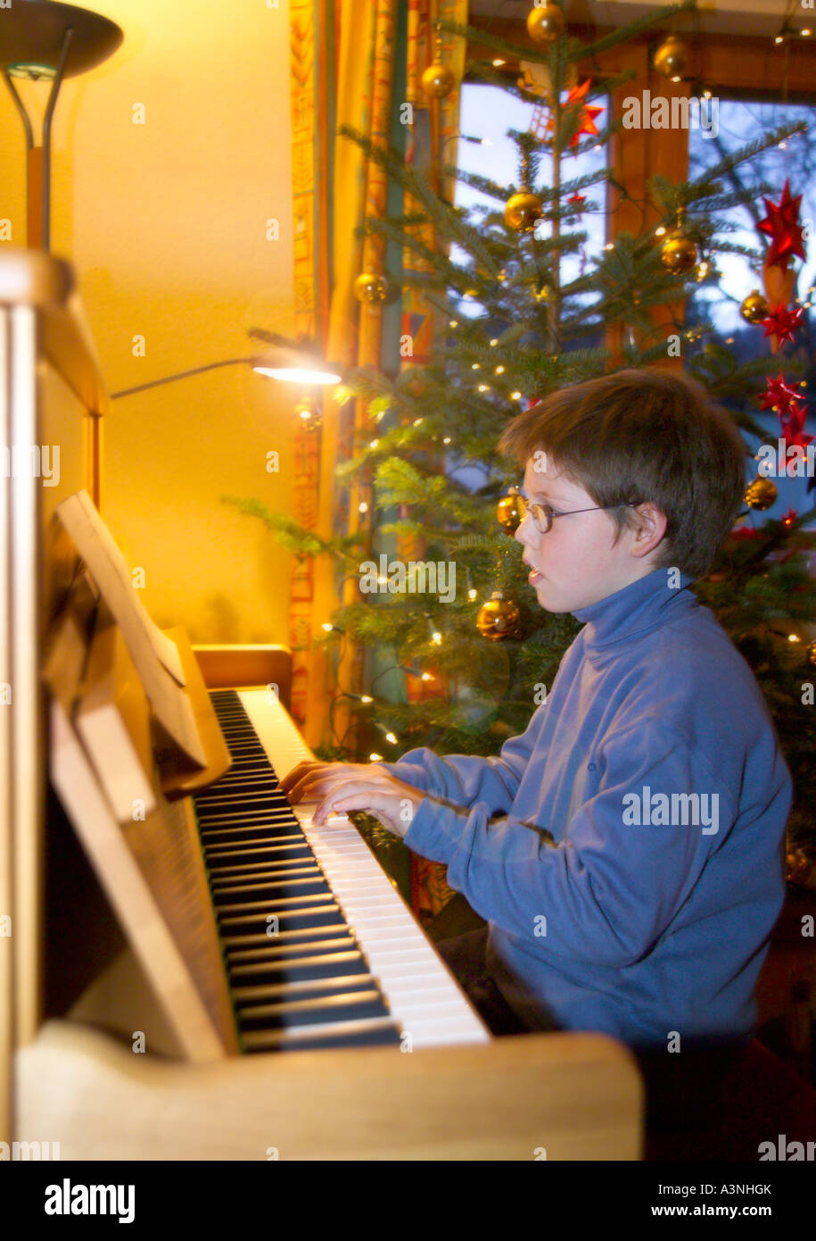 Boy playing piano Stock Photo - Alamy