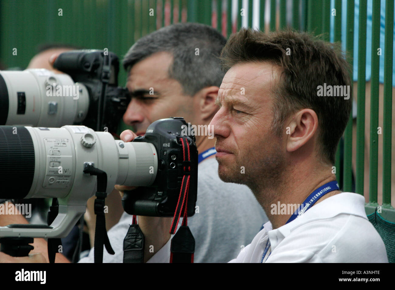 Sport photographers at tennis match Stock Photo - Alamy