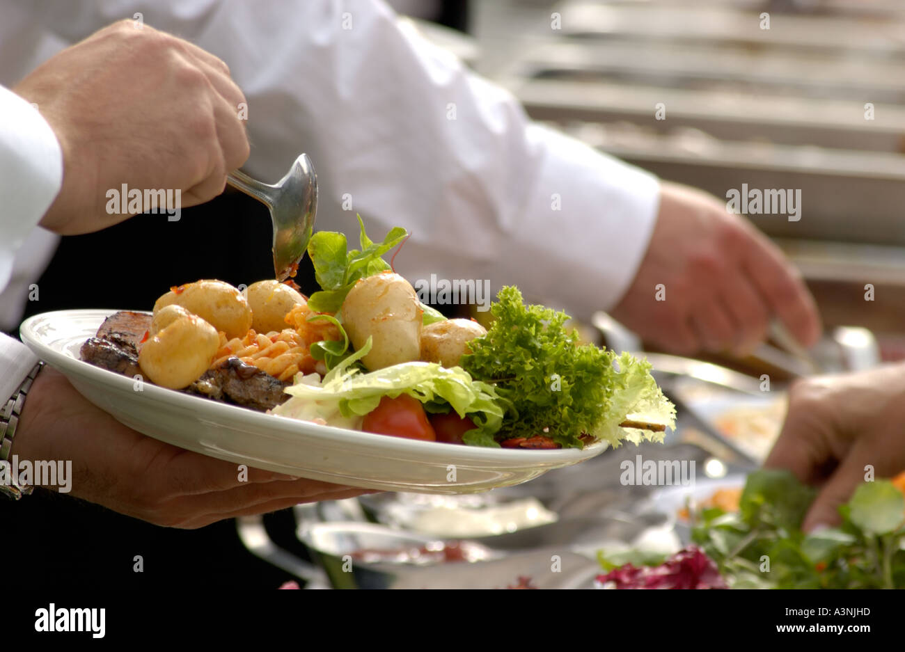 hands self serving food at buffet Stock Photo - Alamy