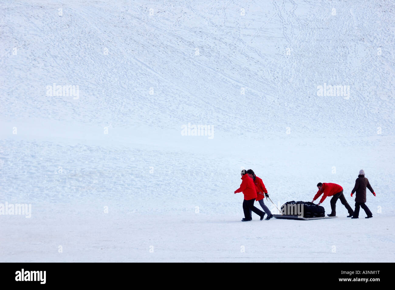 A group of 4 people hauling a sledge across an icy wasteland. Space for ...