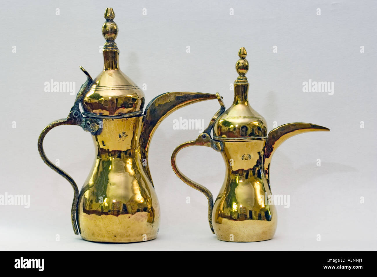 Two brass Arabic coffee pots from Sultanate of Oman Stock Photo - Alamy