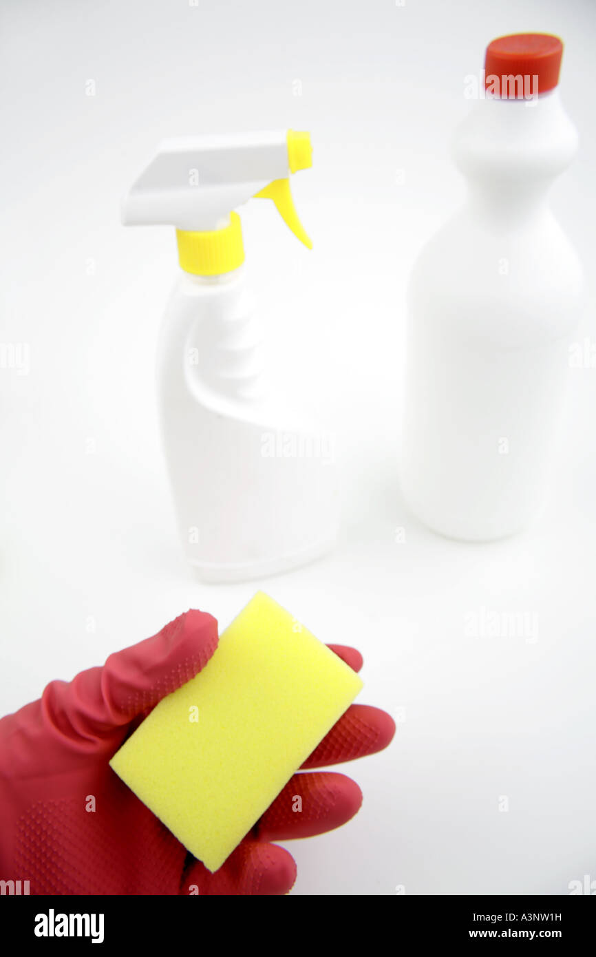 Sponge in gloved hand and bottles Stock Photo - Alamy