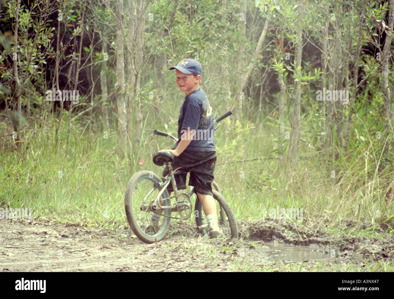A YOUNG BOY RIDING HIS BICYCLE THROUGH THE BUSH Stock Photo - Alamy