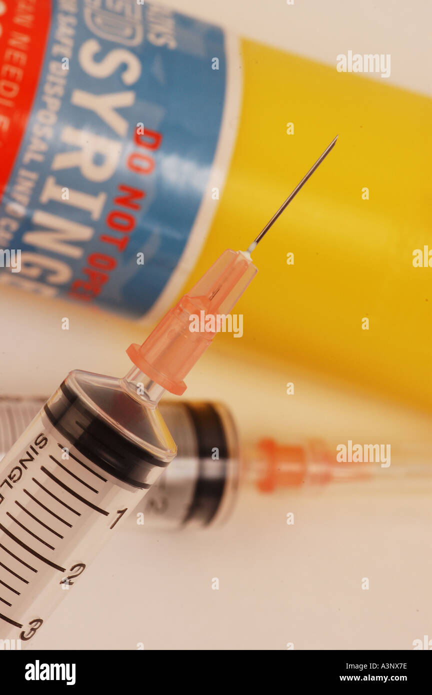 Hypodermic Syringe and sharps container dsca 0782 Stock Photo - Alamy
