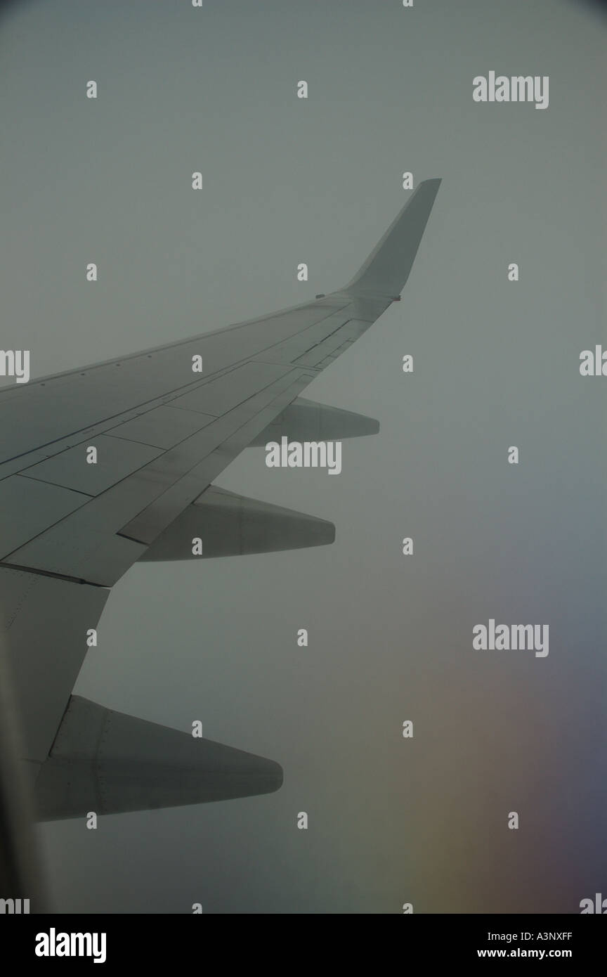 Lost in fog aircraft wing on landing approach dsca 1155 Stock Photo - Alamy