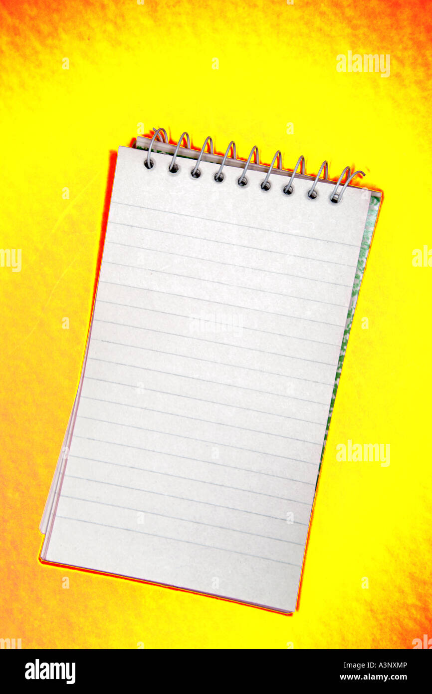 Notepad on yellow background Stock Photo - Alamy