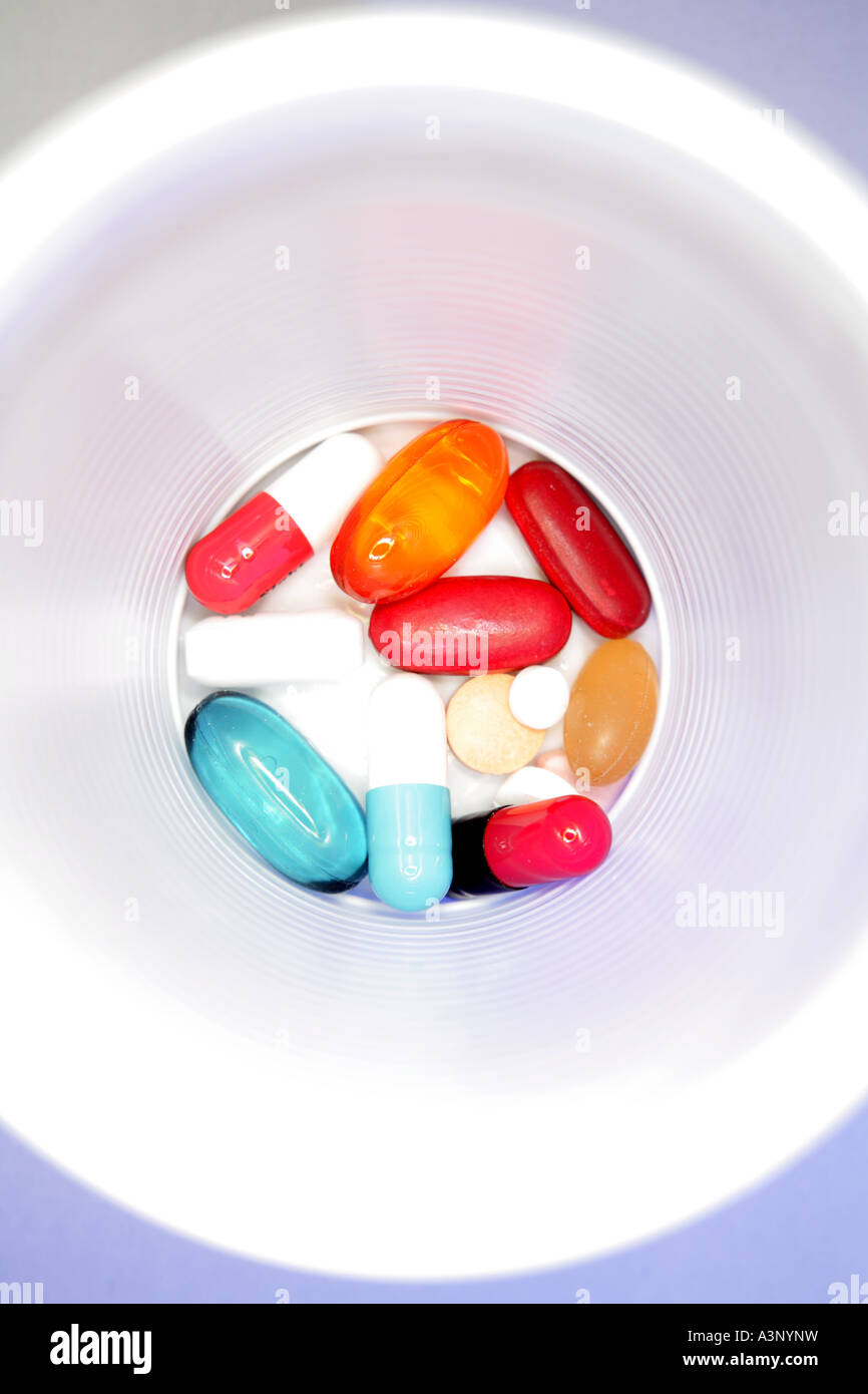 Pills in cup Stock Photo - Alamy