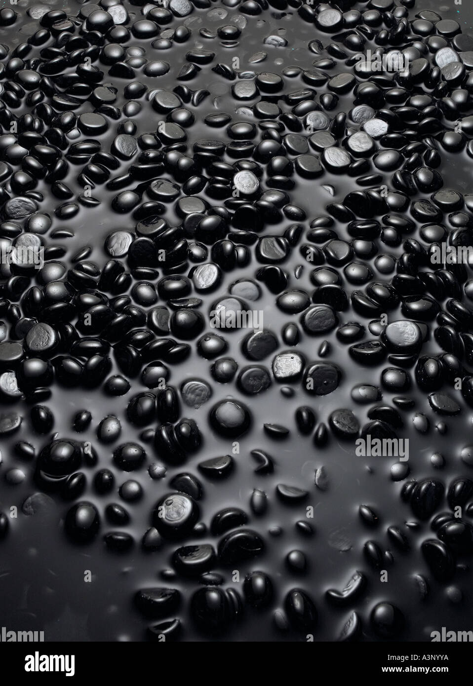 Black Rocks In Stream Water Stock Photo - Alamy