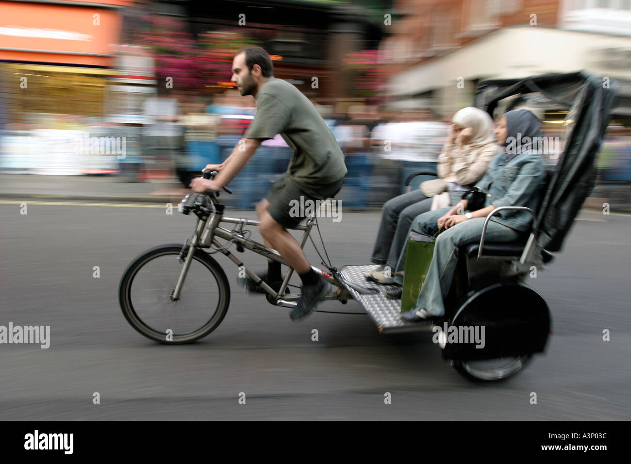 Man riding a rickshaw in soho London Stock Photo - Alamy