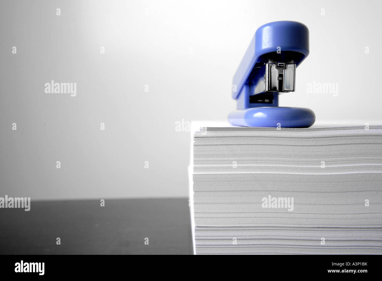 Stapler on top of papers Stock Photo - Alamy