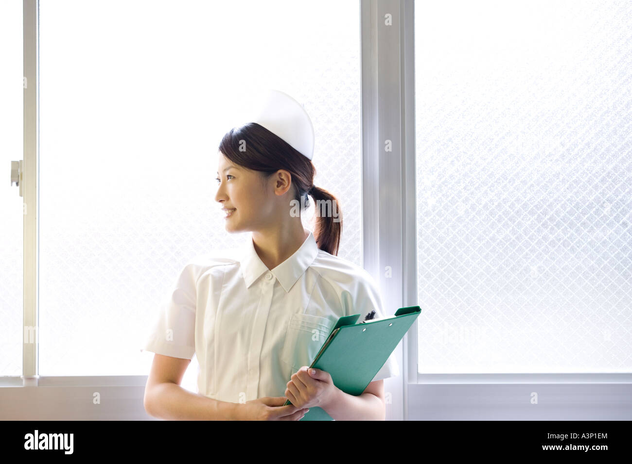 A female nurse holding files Stock Photo - Alamy