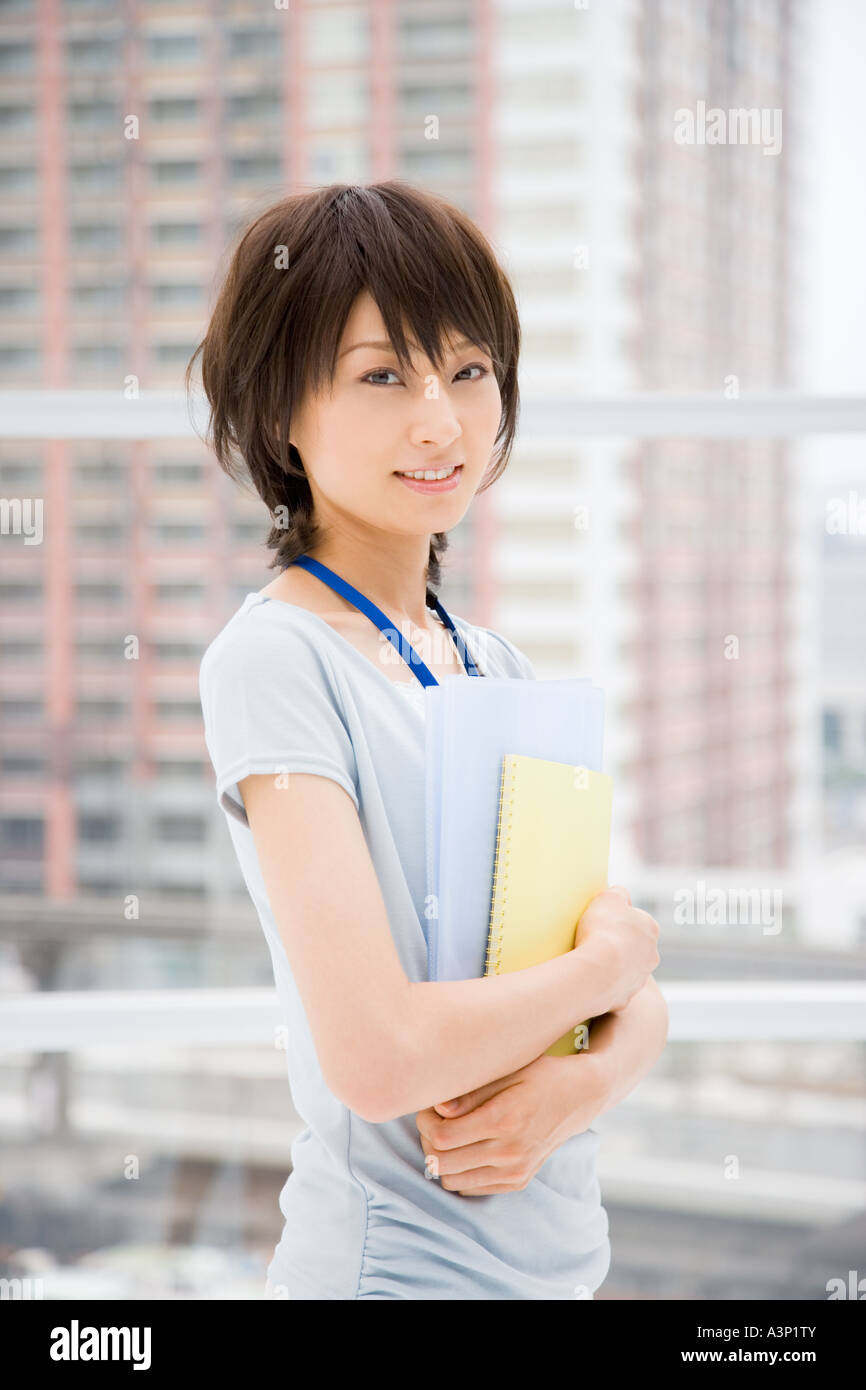 Young woman holding files Stock Photo - Alamy