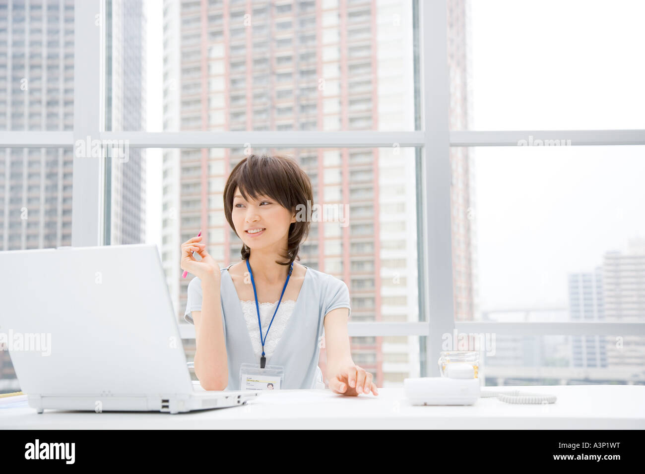 Young woman looking at computer monitor Stock Photo - Alamy