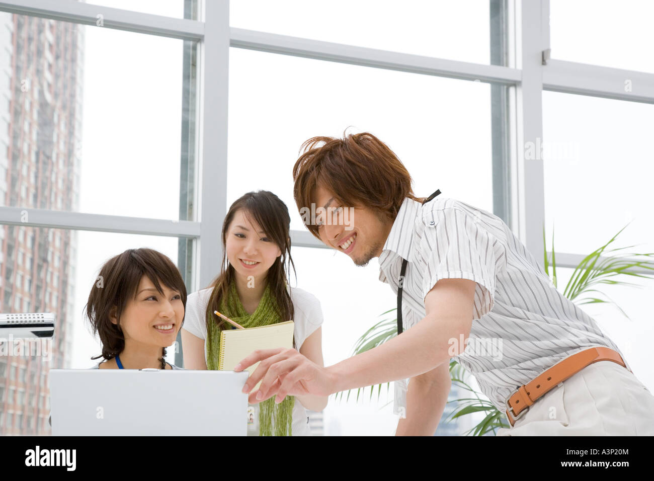 Three people discussing Stock Photo - Alamy