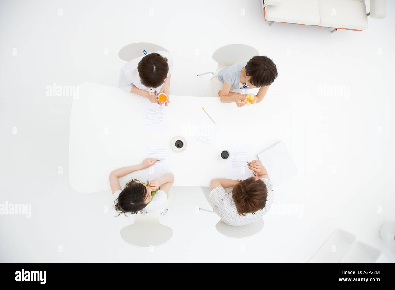 Four people meeting at table Stock Photo - Alamy
