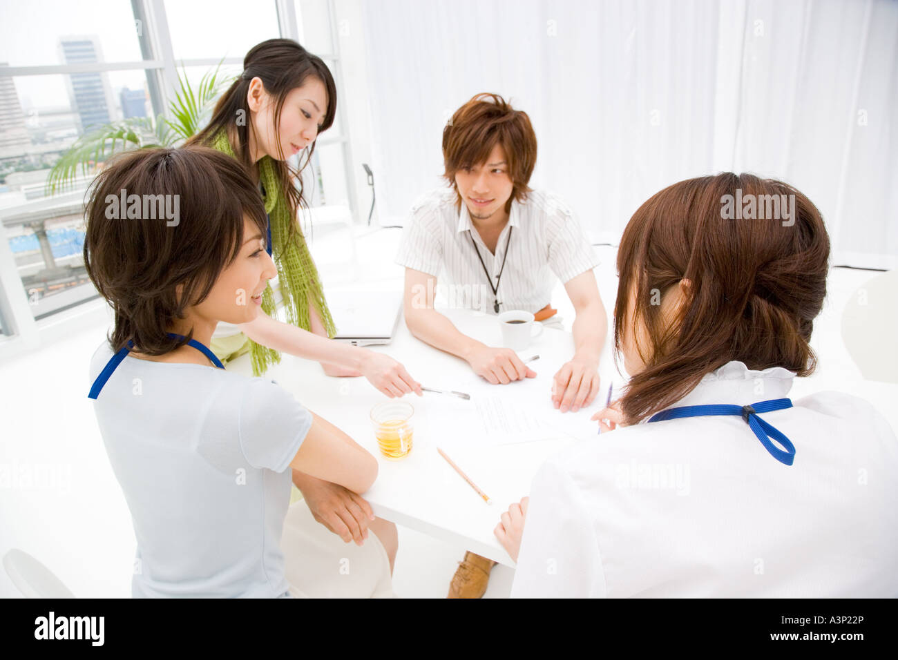 Four people meeting at table Stock Photo - Alamy
