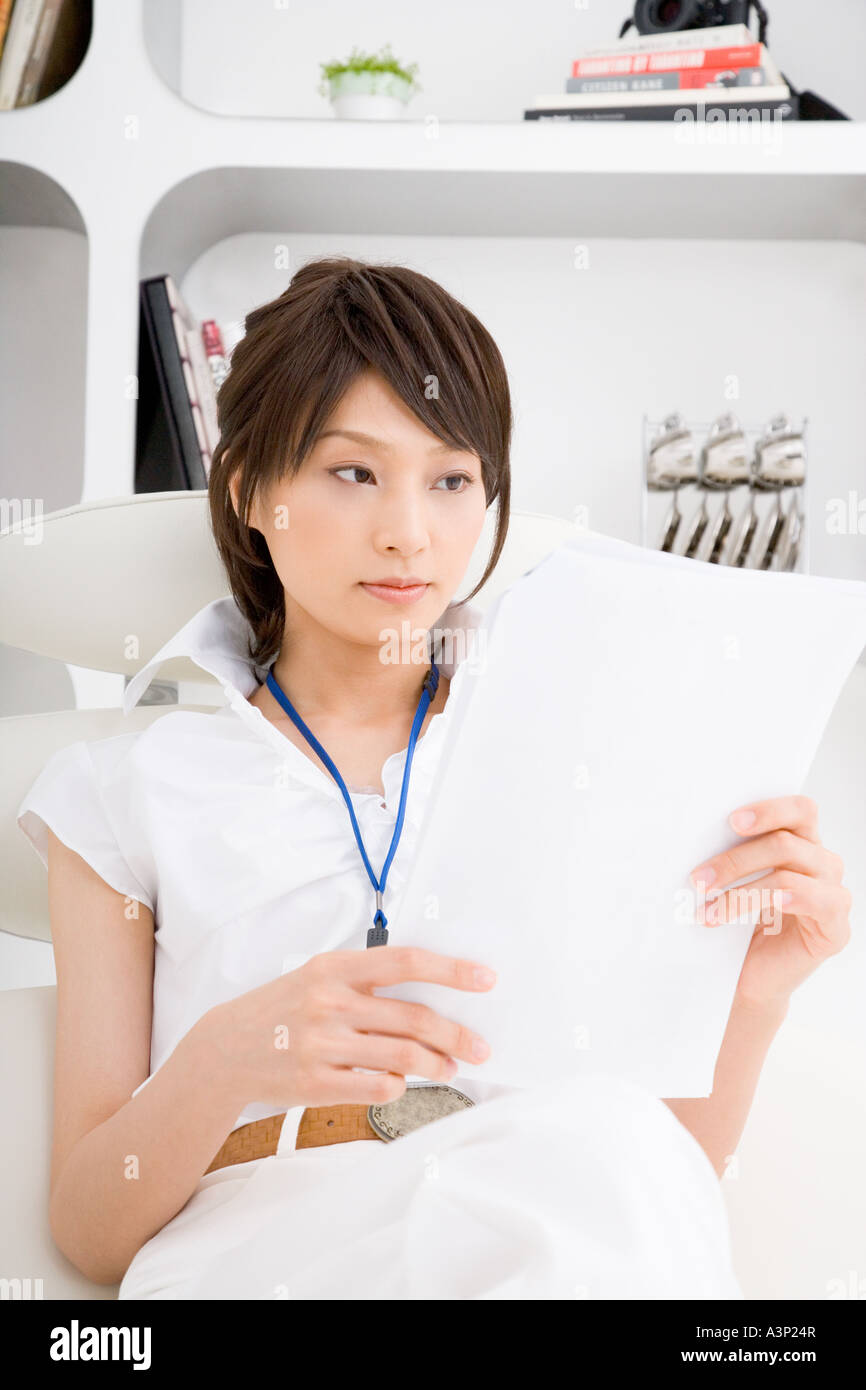 A young woman reading document Stock Photo - Alamy
