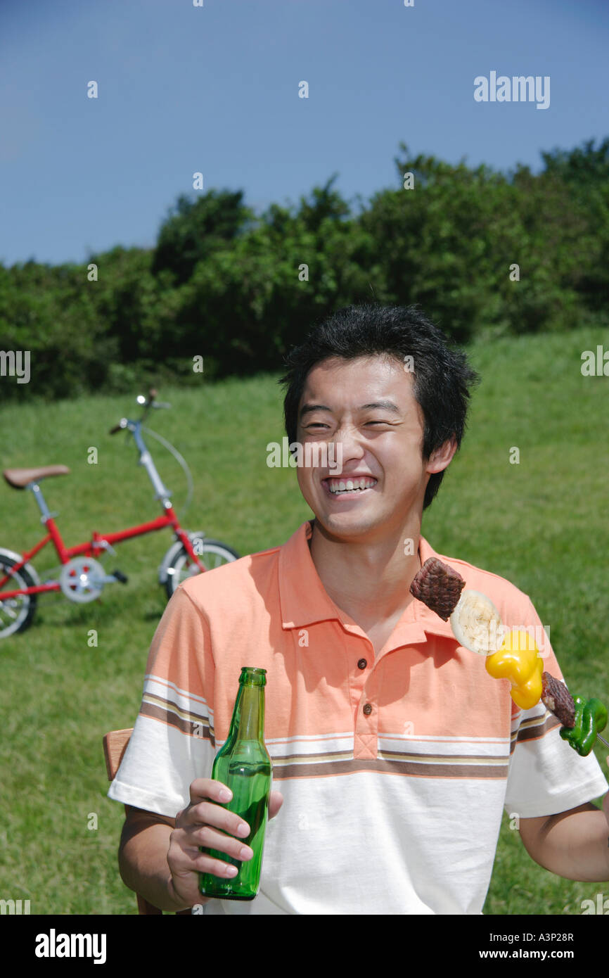 Young man eating kebab outside Stock Photo - Alamy