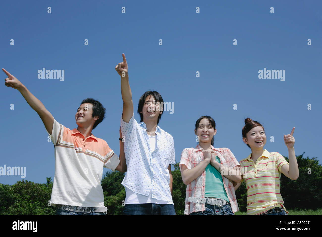 Four young people pointing directions Stock Photo - Alamy