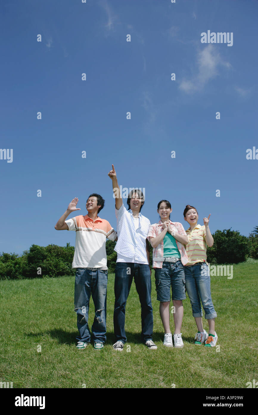 Four young people pointing directions Stock Photo - Alamy
