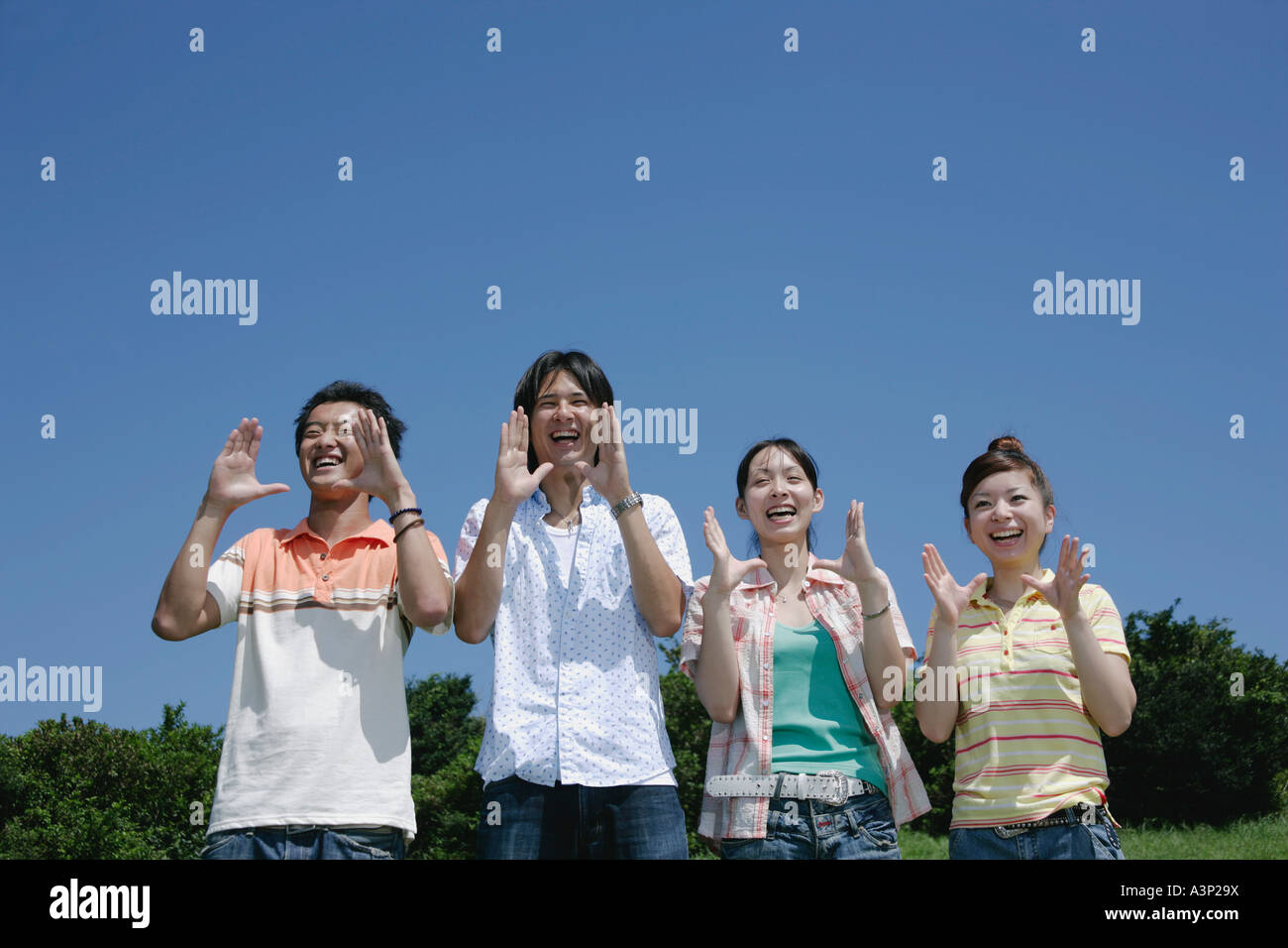 Four young people yelling Stock Photo - Alamy