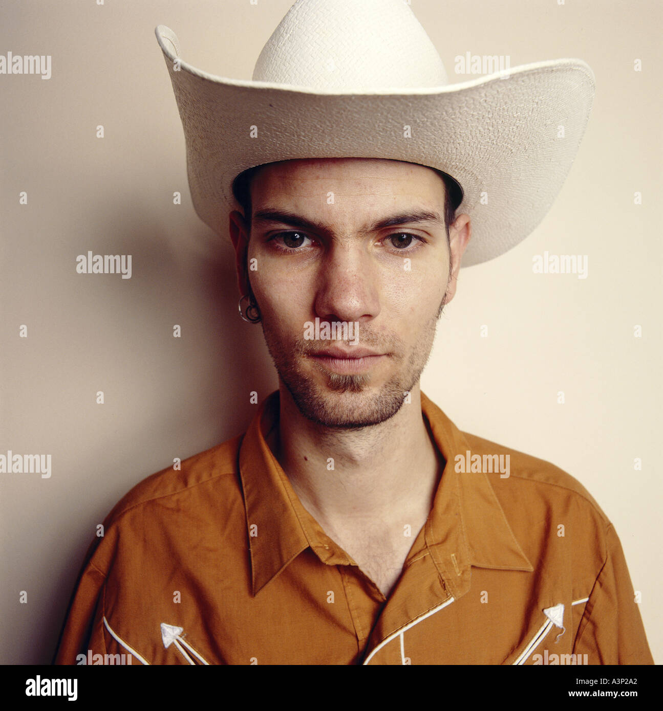 Young man wearing cowboy hat, portrait Stock Photo - Alamy