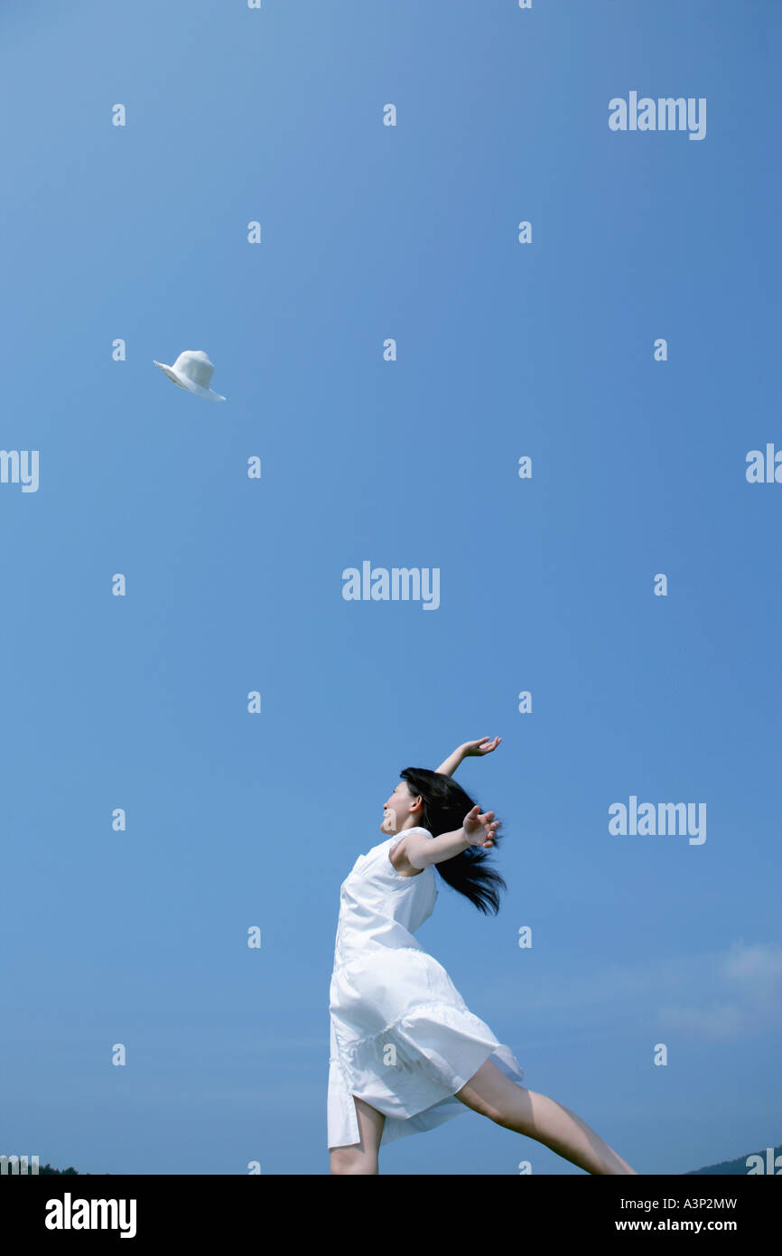 A young woman throwing a hat Stock Photo - Alamy