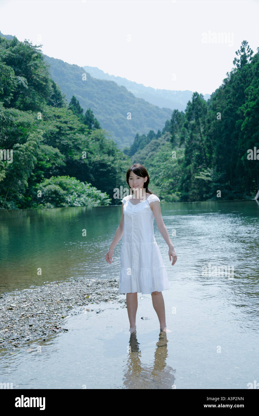 A young woman standing in river Stock Photo - Alamy