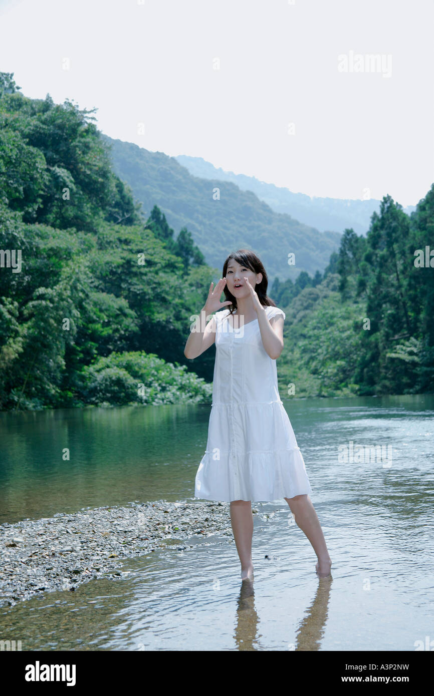 A young woman shouting in river Stock Photo - Alamy